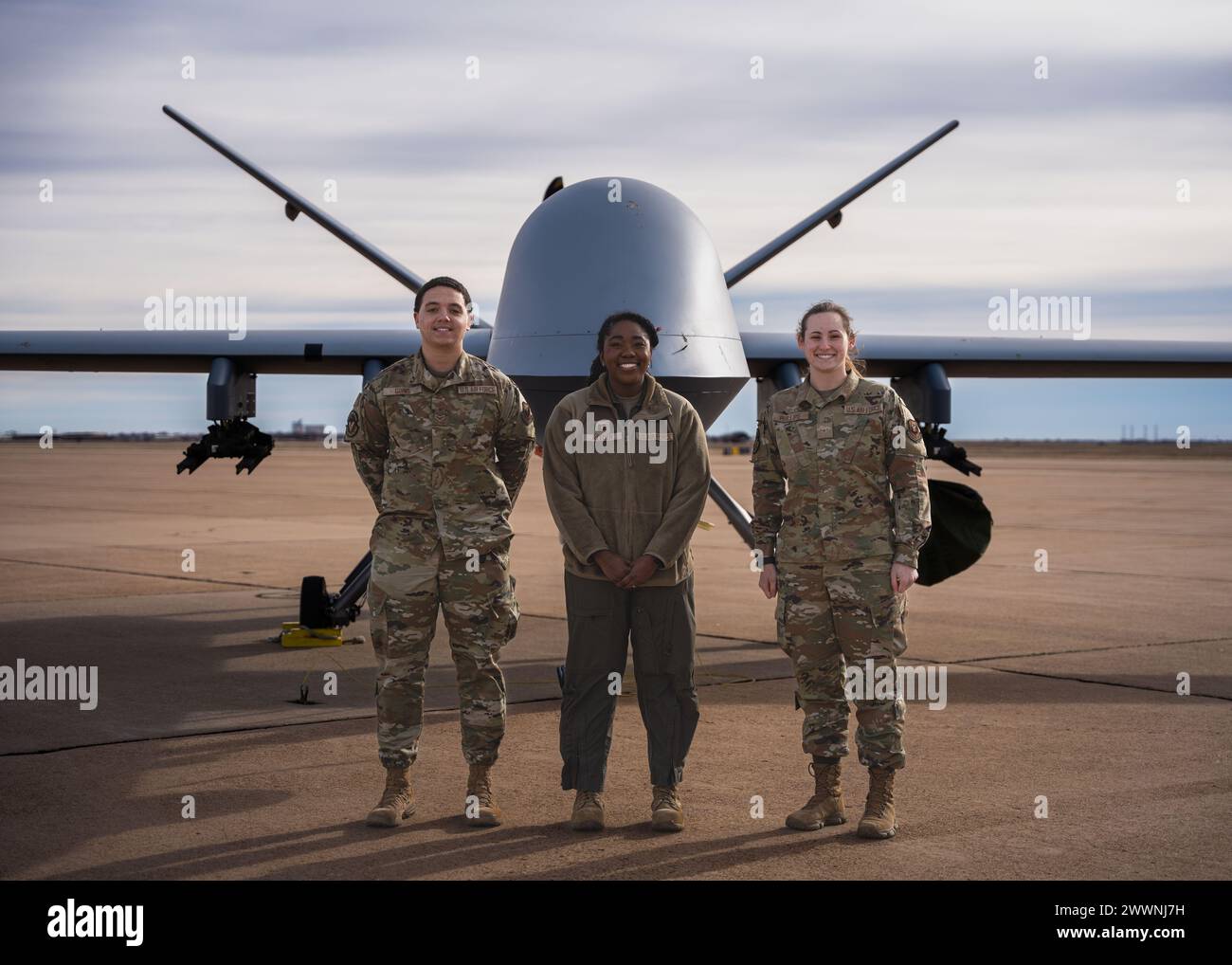 Airmen pose for a photo with a 27th Special Operations Wing MQ-9 Reaper ...