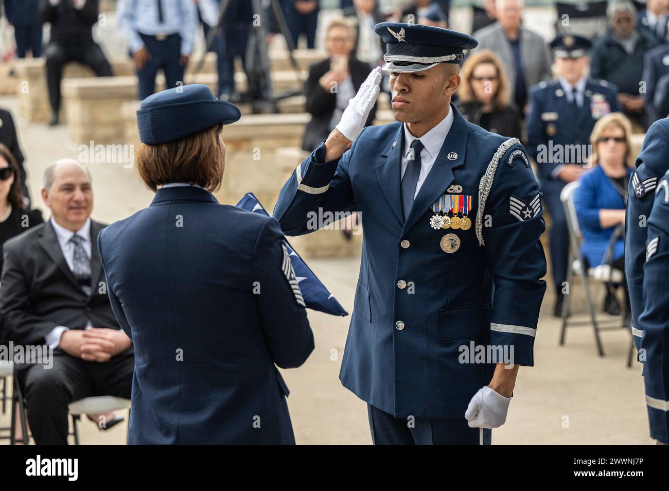 A U.S. Air Force Honor Guard member salutes the U.S. flag during the ...