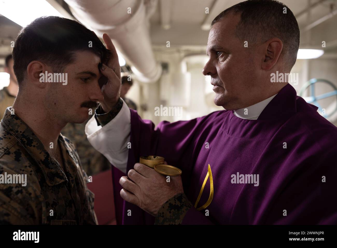 U.S. Navy Cmdr. Daniel Fullerton, right, the chaplain of the amphibious ...