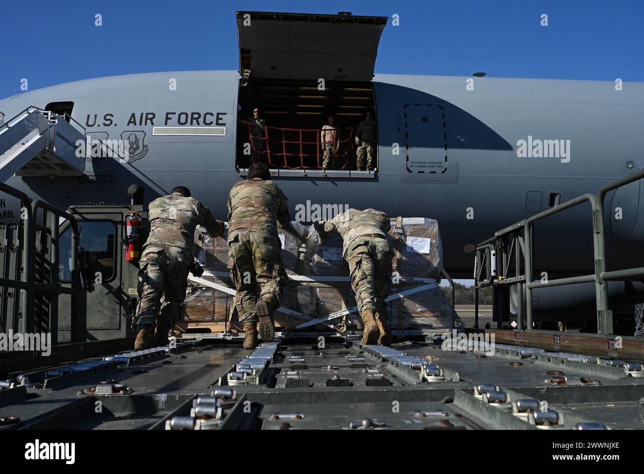 Airmen assigned to the 19th Logistics Readiness Squadron push a cargo ...