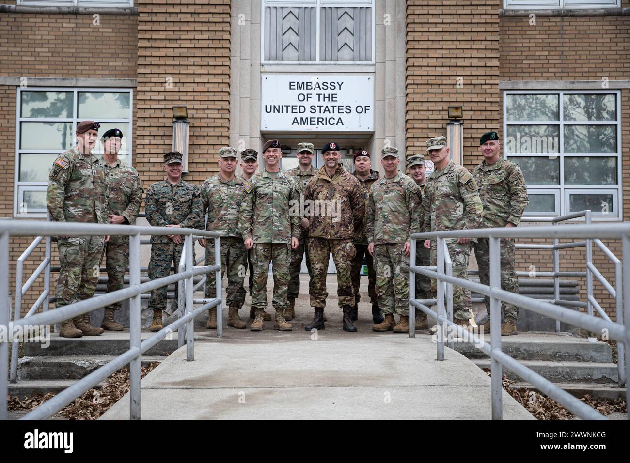 Distinguished visitors pose for a group photo during a review of ...