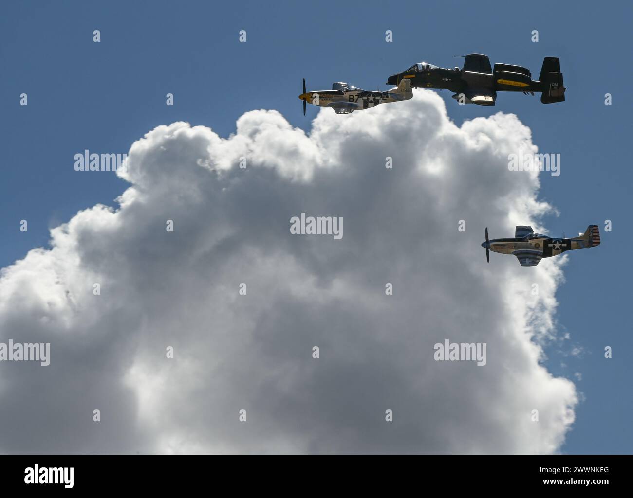 An A-10 Thunderbolt II aircraft flies alongside two P-51 Mustang ...