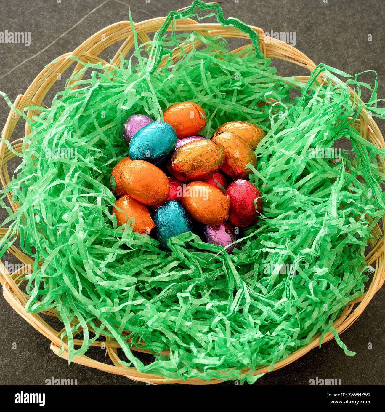 Close up on Easter Nest standing on black table, with colorful shiny ...