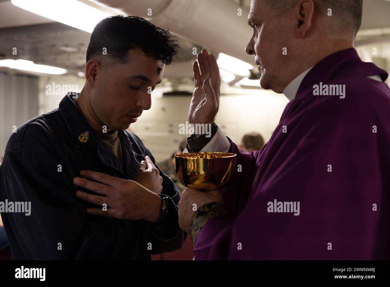 U.S. Navy Cmdr. Daniel Fullerton, right, the chaplain of the amphibious ...