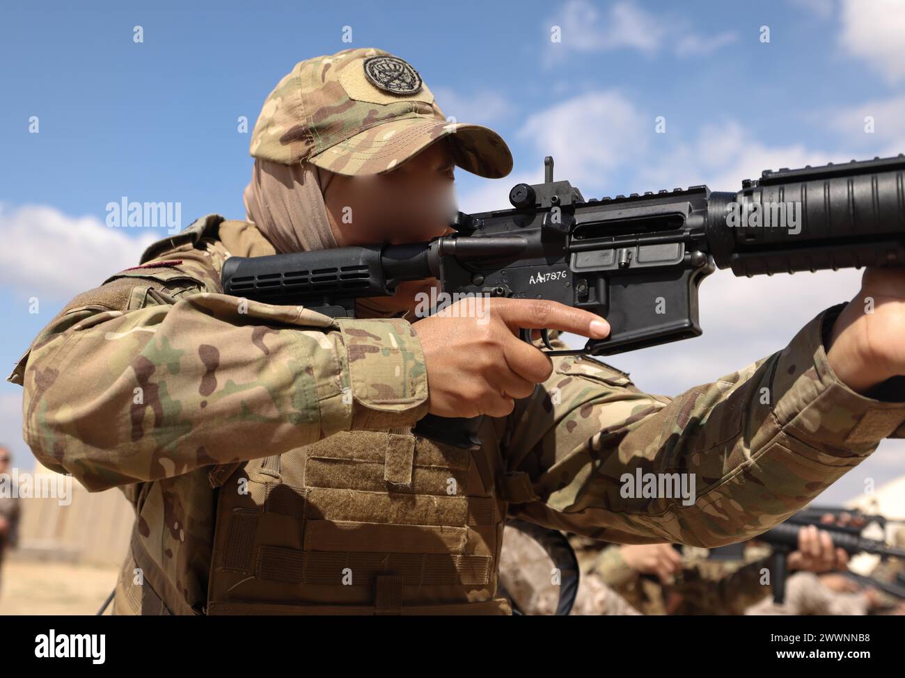 A Jordanian Soldier assigned to the Quick Response Force Brigade fires ...