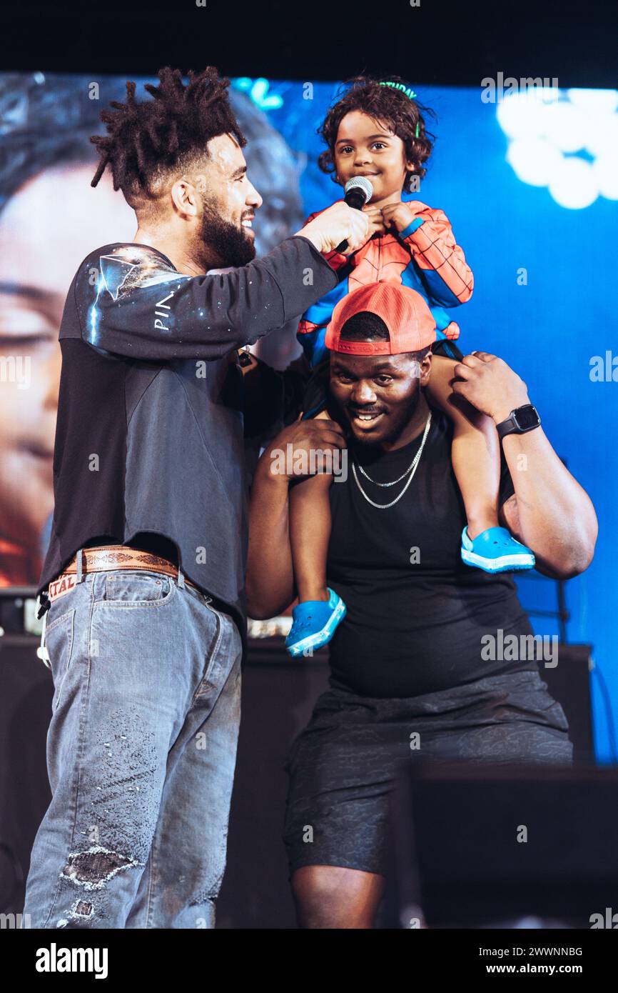 Kyle Harvey, a musical artist and rapper, invites attendees on stage ...