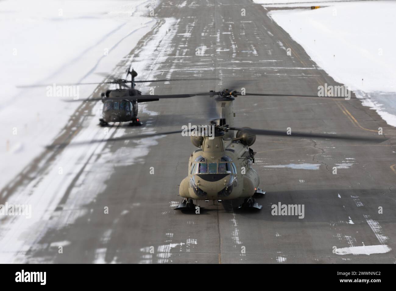 An Alaska Army National Guard CH-47F Chinook helicopter, foreground ...