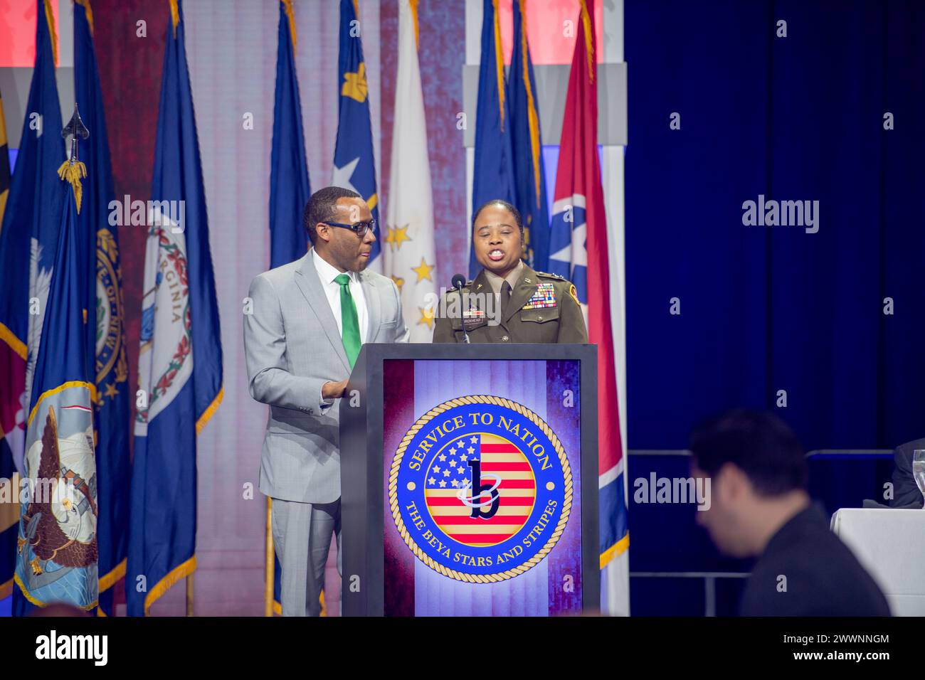 Jason Newton and U.S Army Major Gen. Janeen Birckhead, share the podium ...