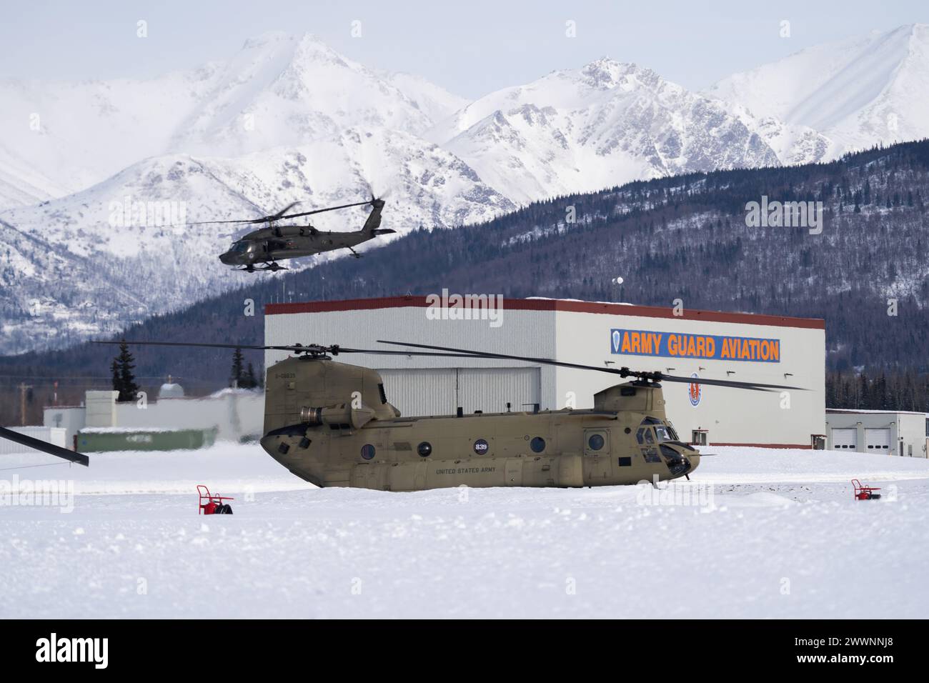 An Alaska Army National Guard UH-60L Black Hawk helicopter flies by as ...