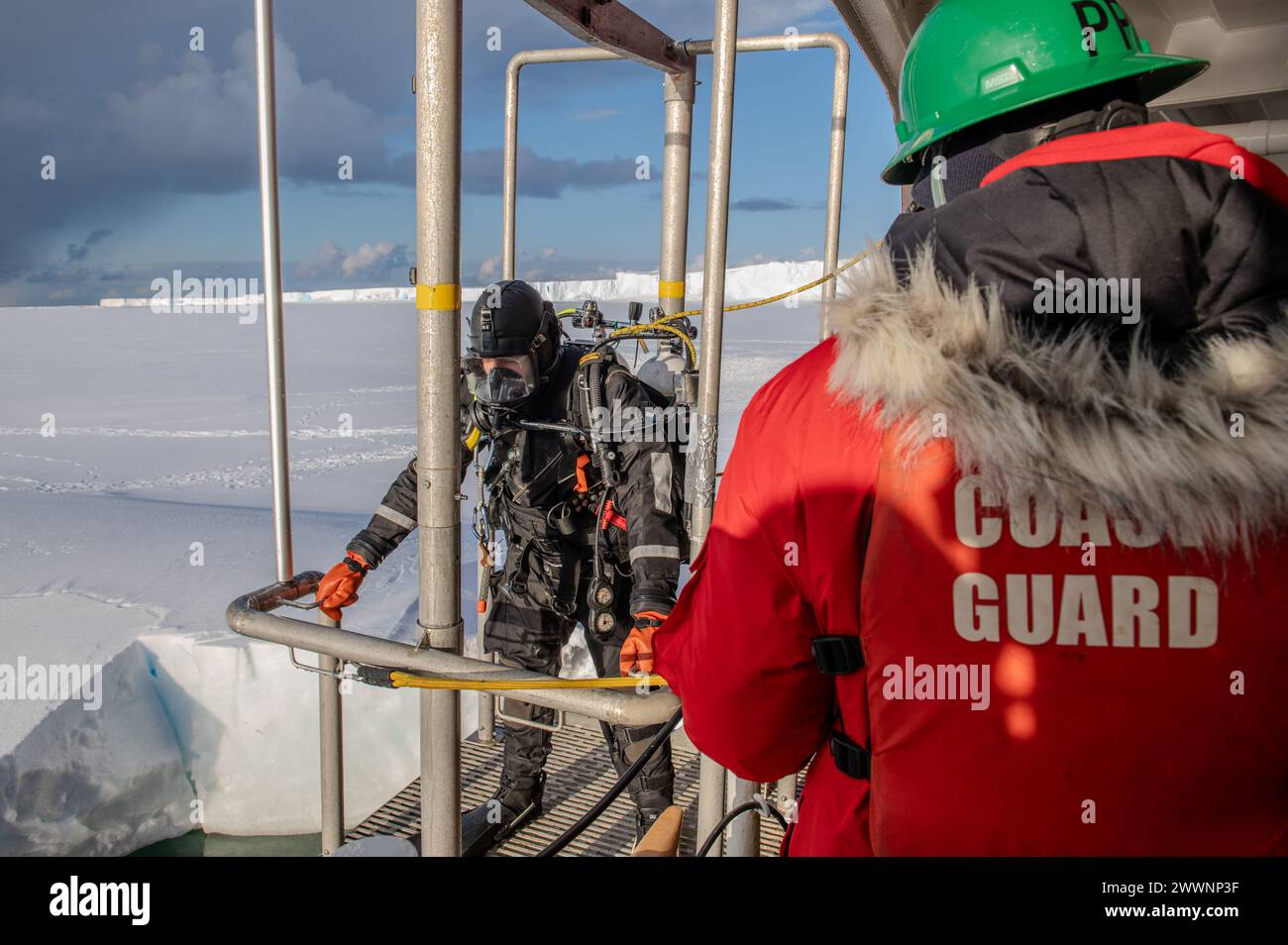 U.S. Coast Guard Petty Officer 1st Class Casey Connors, a diver, stands ...