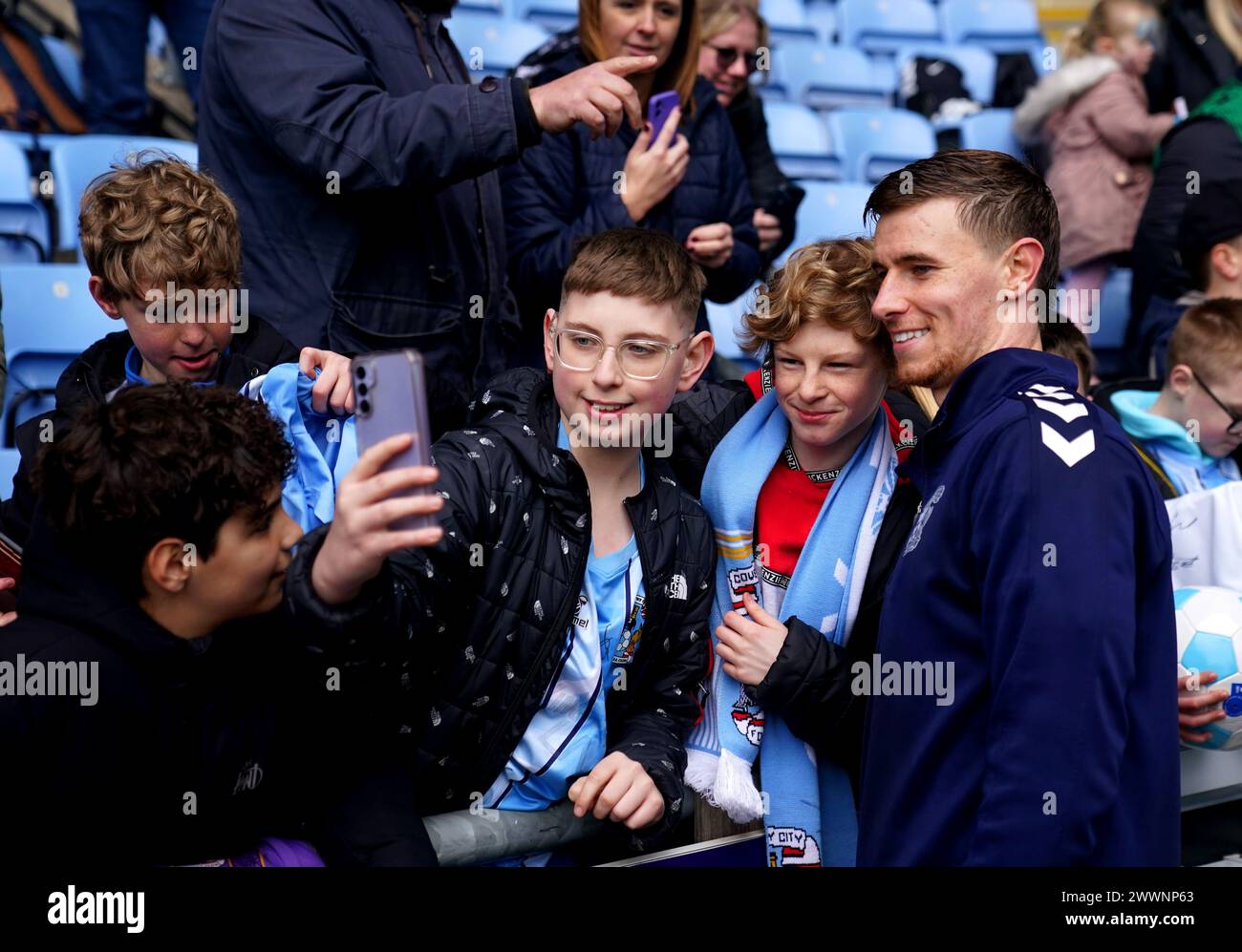 Coventry City's Ben Sheaf poses for photos with fans after a training ...