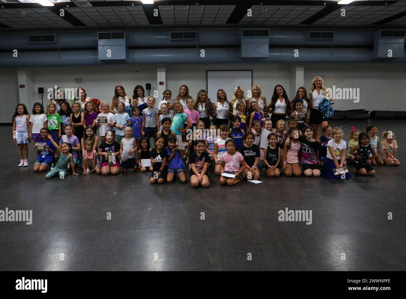 NFL cheerleaders and children pose for a picture during the Armed ...