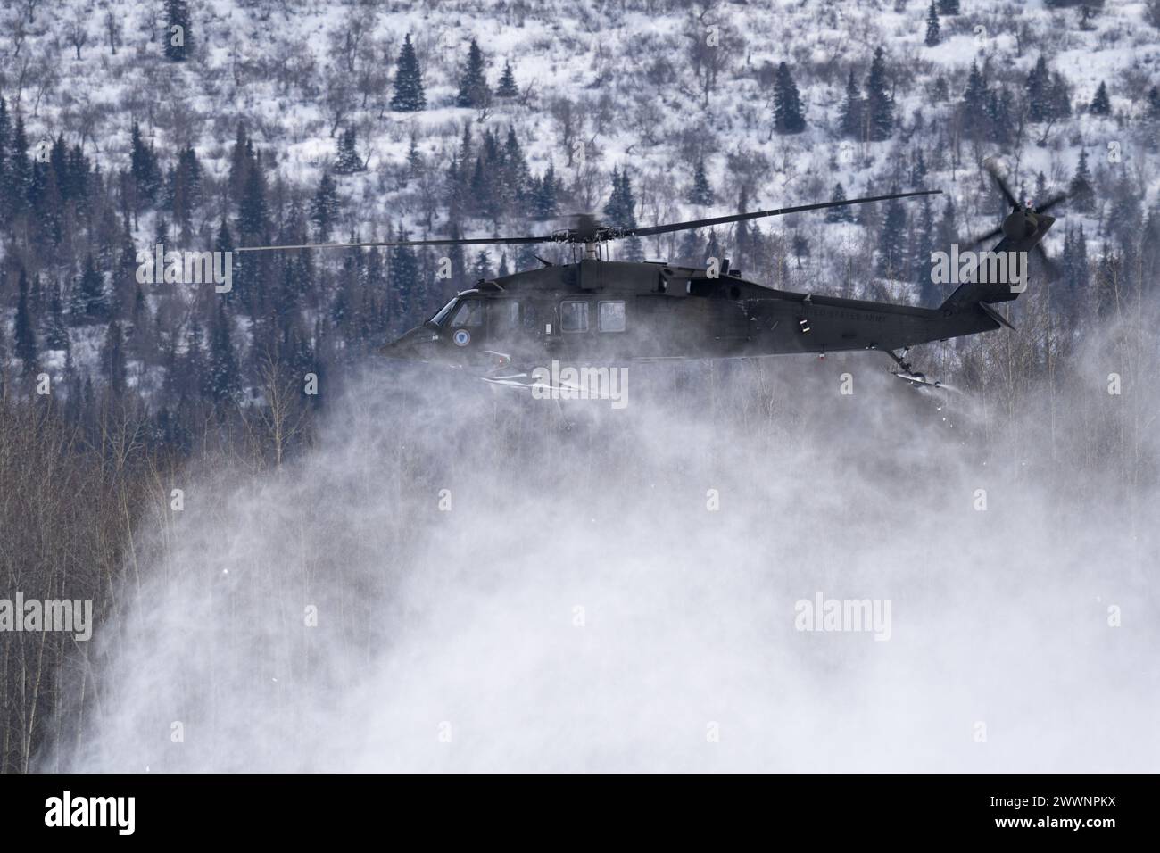 Snow kicks up as an Alaska Army National Guard UH-60L Black Hawk ...