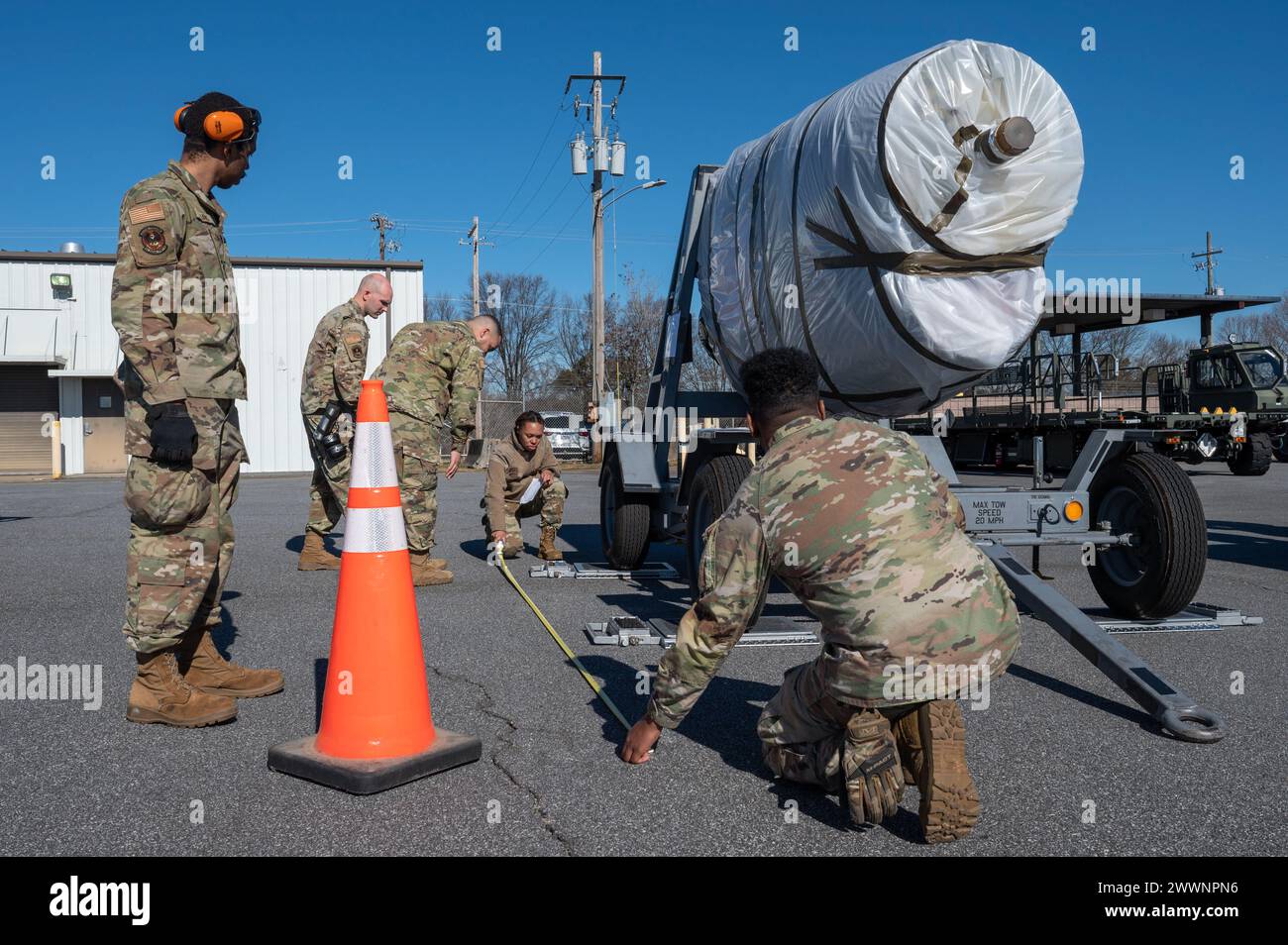 Members of the 94th Logistics Readiness Squadron measure the length of ...