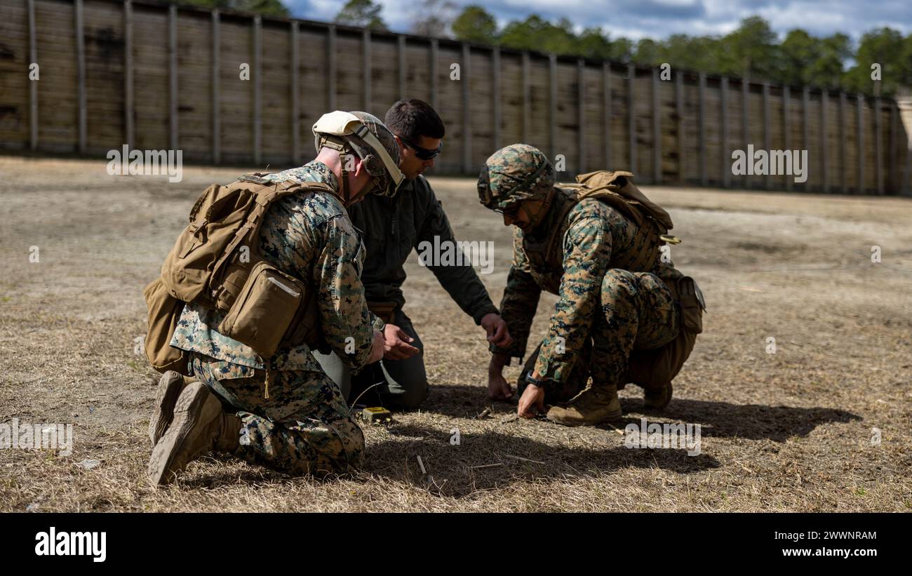 U.S. Marine Corps Sgt. Alex Fiedler, center, an explosive ordnance ...