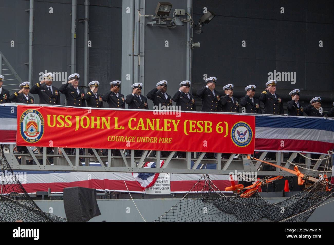 U.S. Navy Sailors salute during the commissioning of the USS John L ...