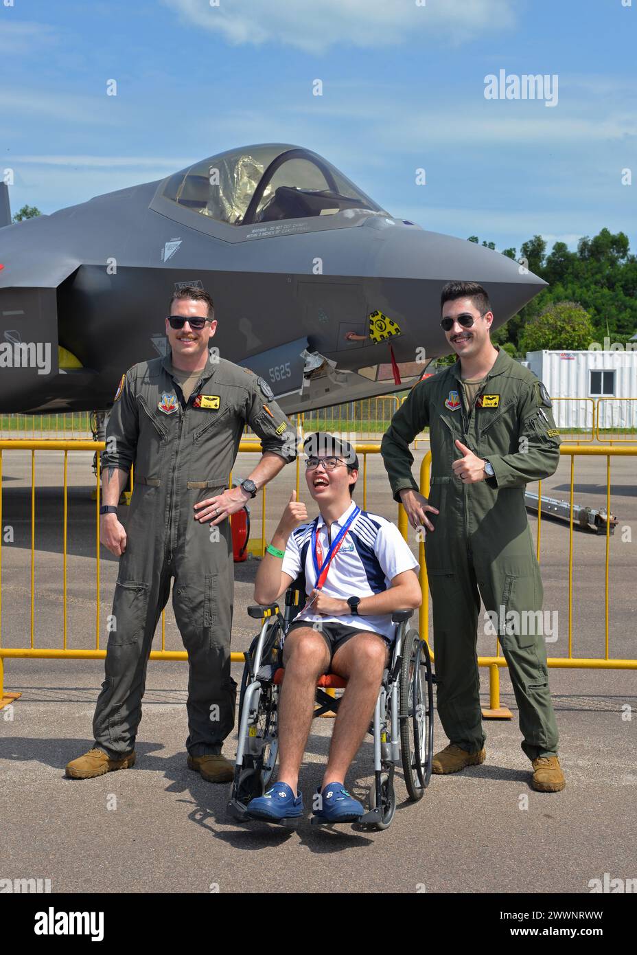 U.S. Air Force F-35A Lightning II pilots pose with a young adult with ...