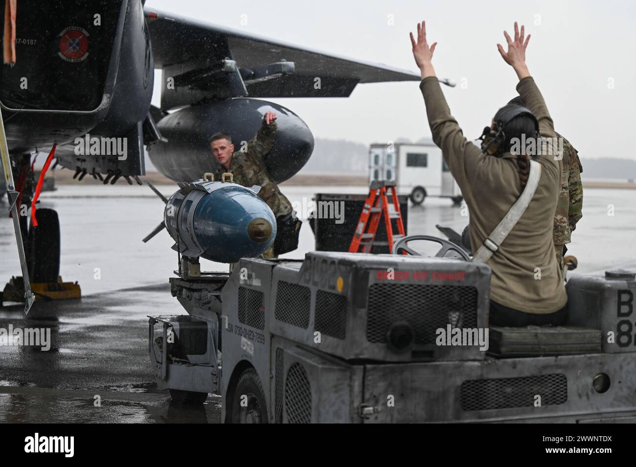 U.S. Air Force Airman 1st Class Kyle Stowers, left, a weapons load crew ...