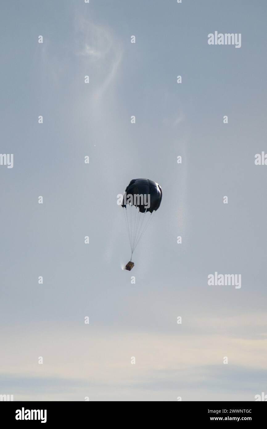 A bundle descends onto Chièvres Drop Zone as U.S. Airmen with the 37th ...