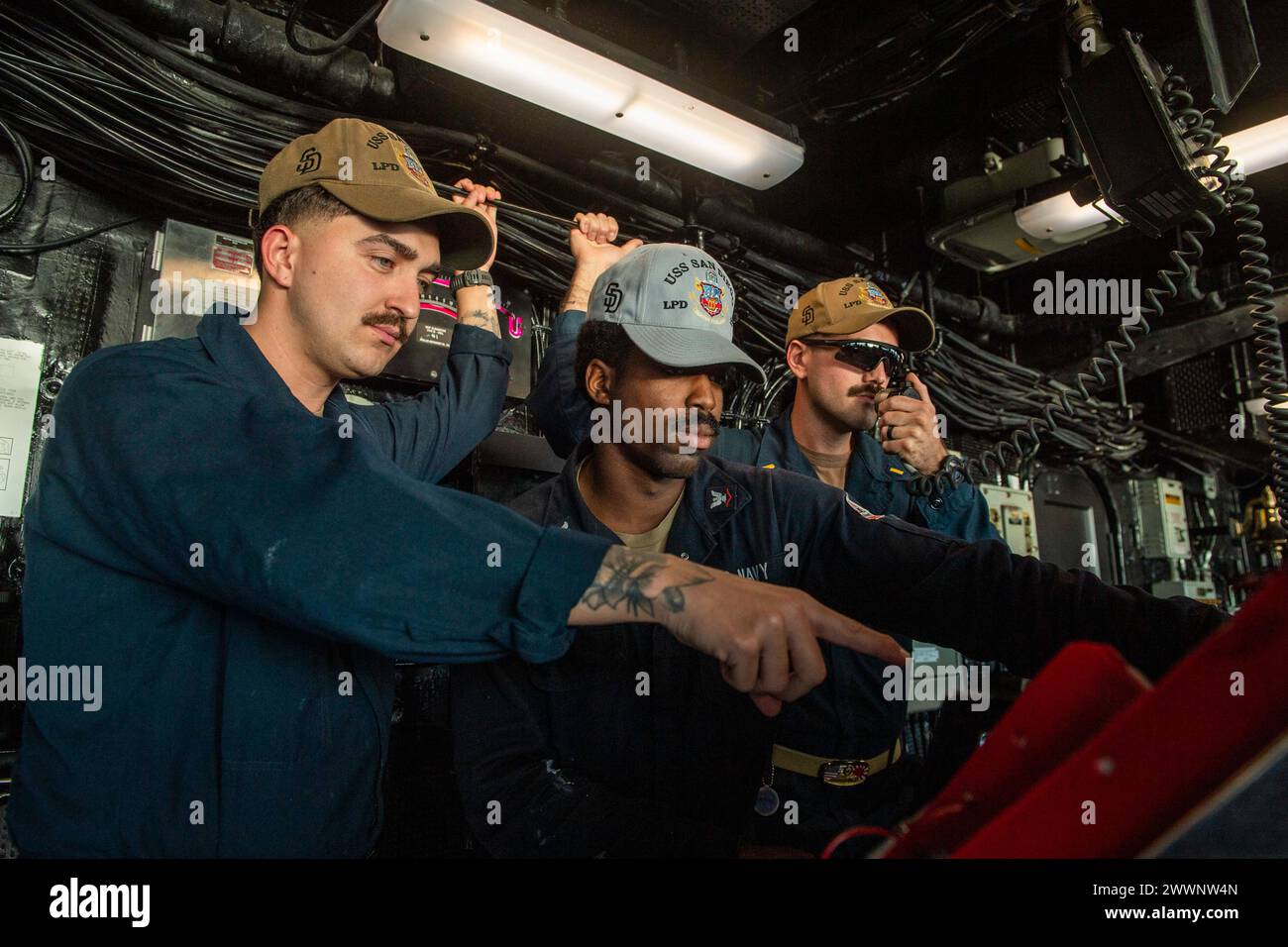 Sailors assigned to USS San Diego (LPD 22) stand watch at the helm ...