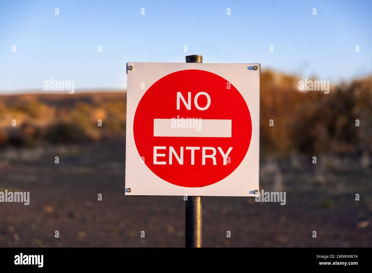 Close up on a NO ENTRY sign and out of focus in the background a semi ...