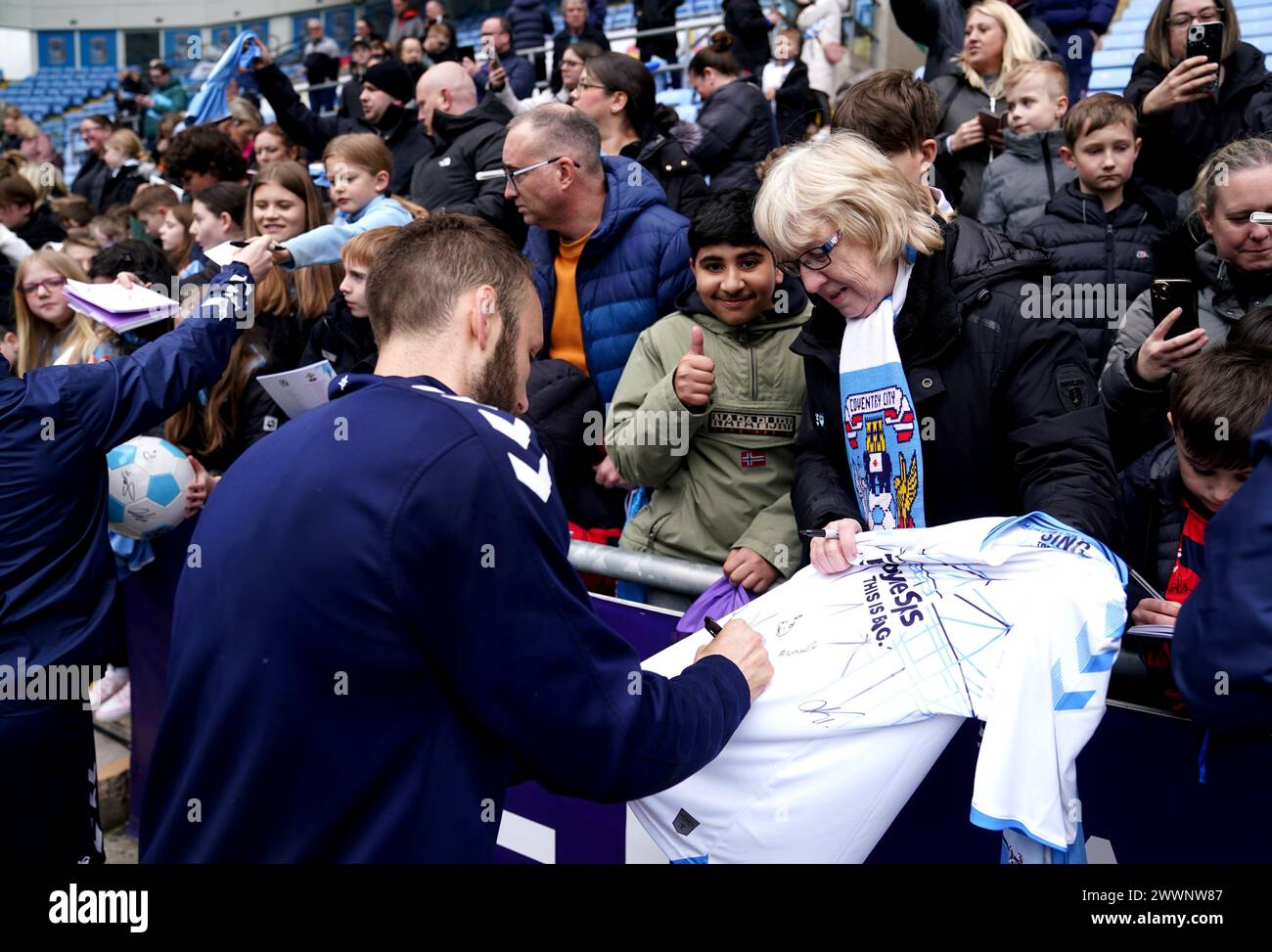 Coventry City's Liam Kelly signs a fans shirt after a training session ...