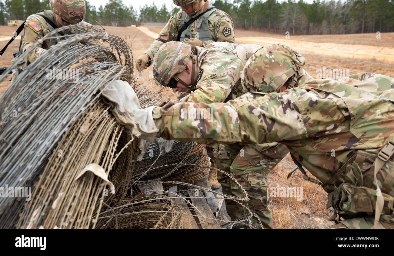 Participants in an engineering competition gather concertina wire to ...