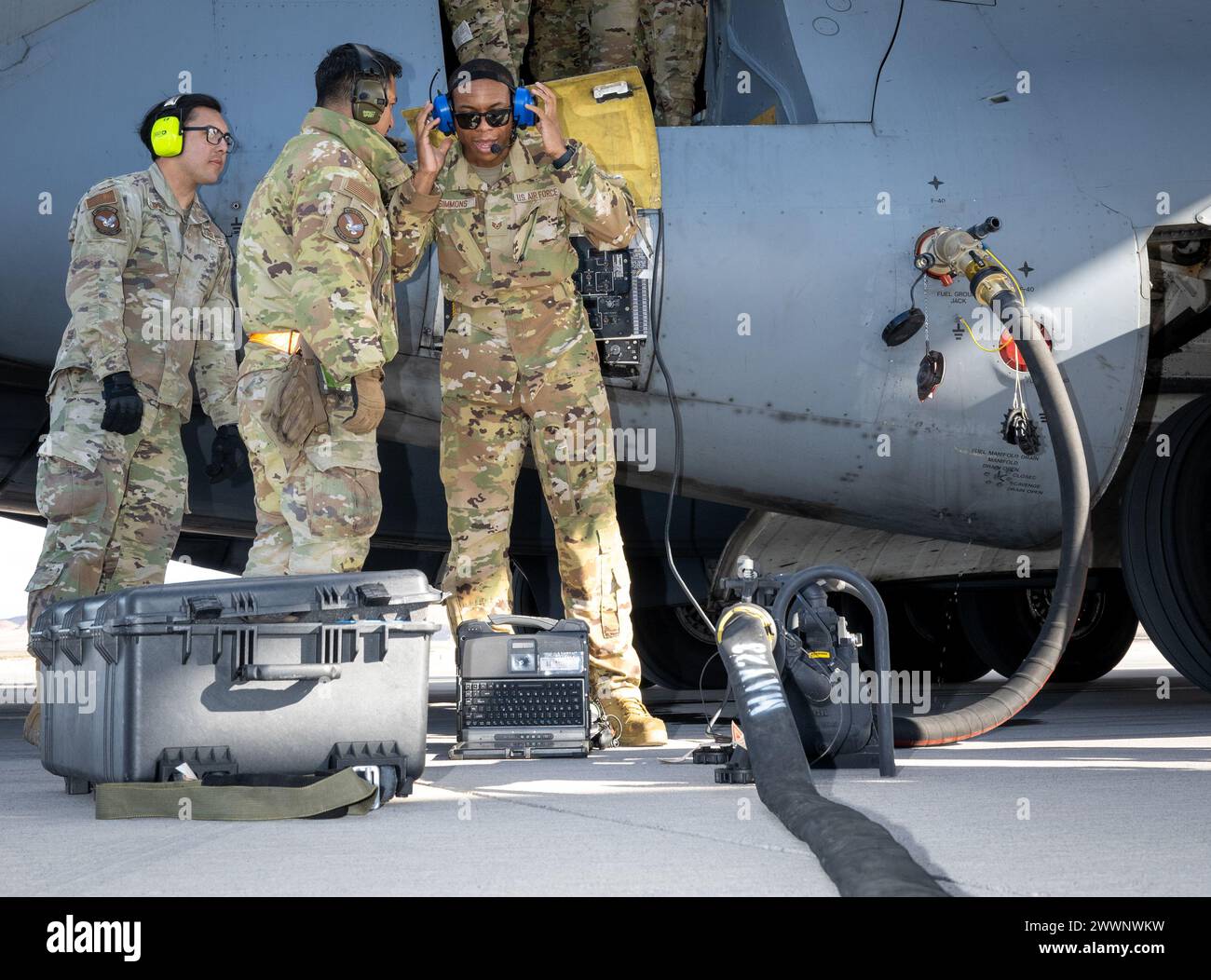 U.S. Air Force Staff Sgt. Dwayne Simmons (right), a flying crew chief ...