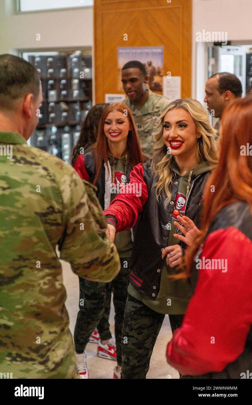 Shannon Currie, a Tampa Bay Buccaneers Cheerleader, shakes hands with a ...