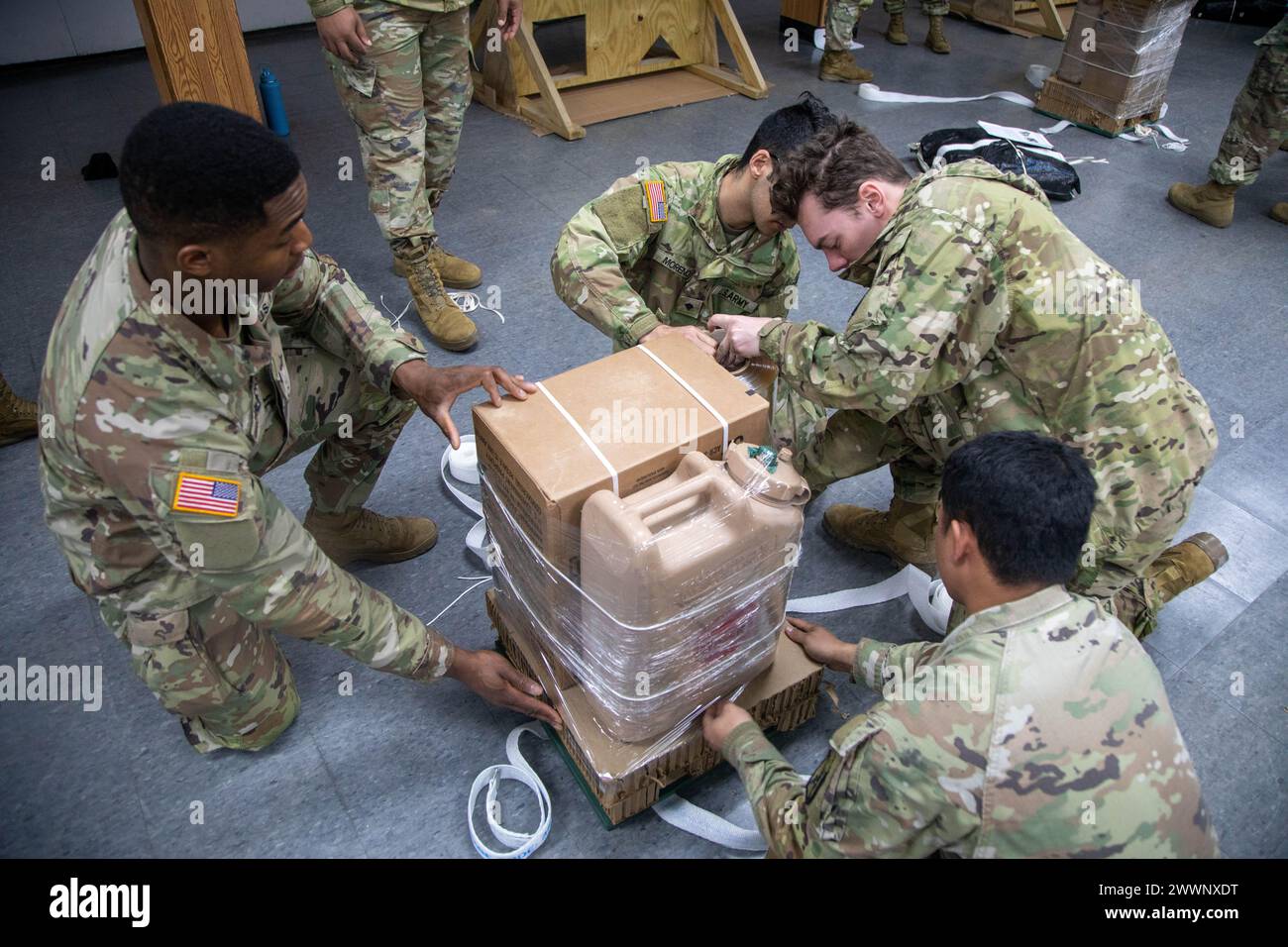 Soldiers with the 10th Mountain Division prepare a drop bundle before ...