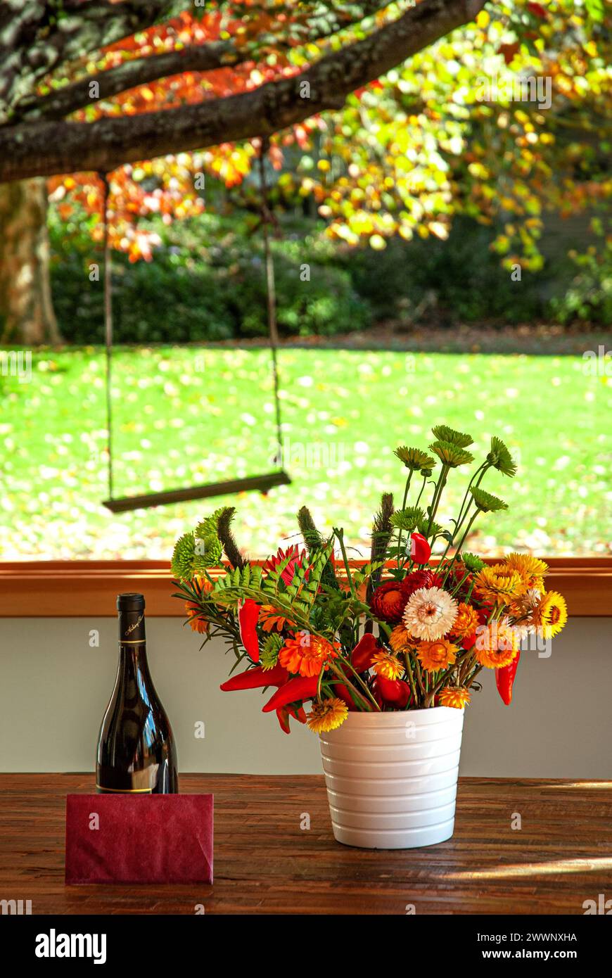 A bottle of wine and a bouquet of flowers offered to owners of newly ...