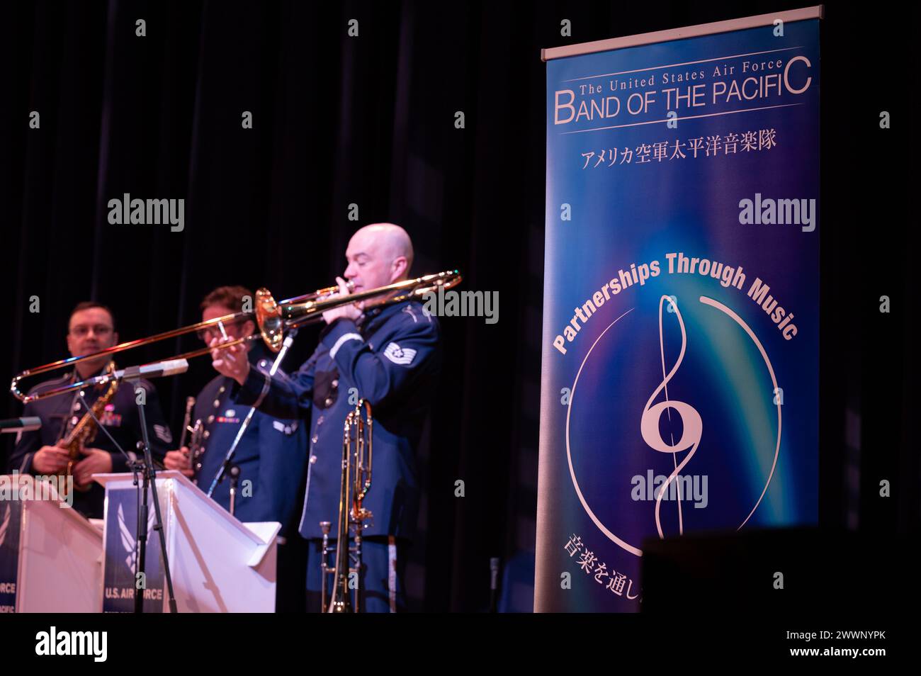 Members of the U.S. Air Force Band of the Pacific perform on stage ...