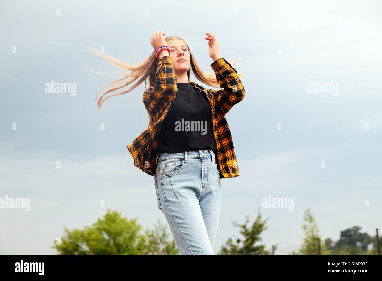 Smiling happy girl. Portrait preteen girl on the gray sky background ...