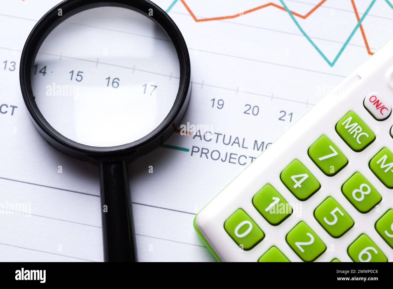 work with a magnifying glass, a calculator and papers Stock Photo - Alamy