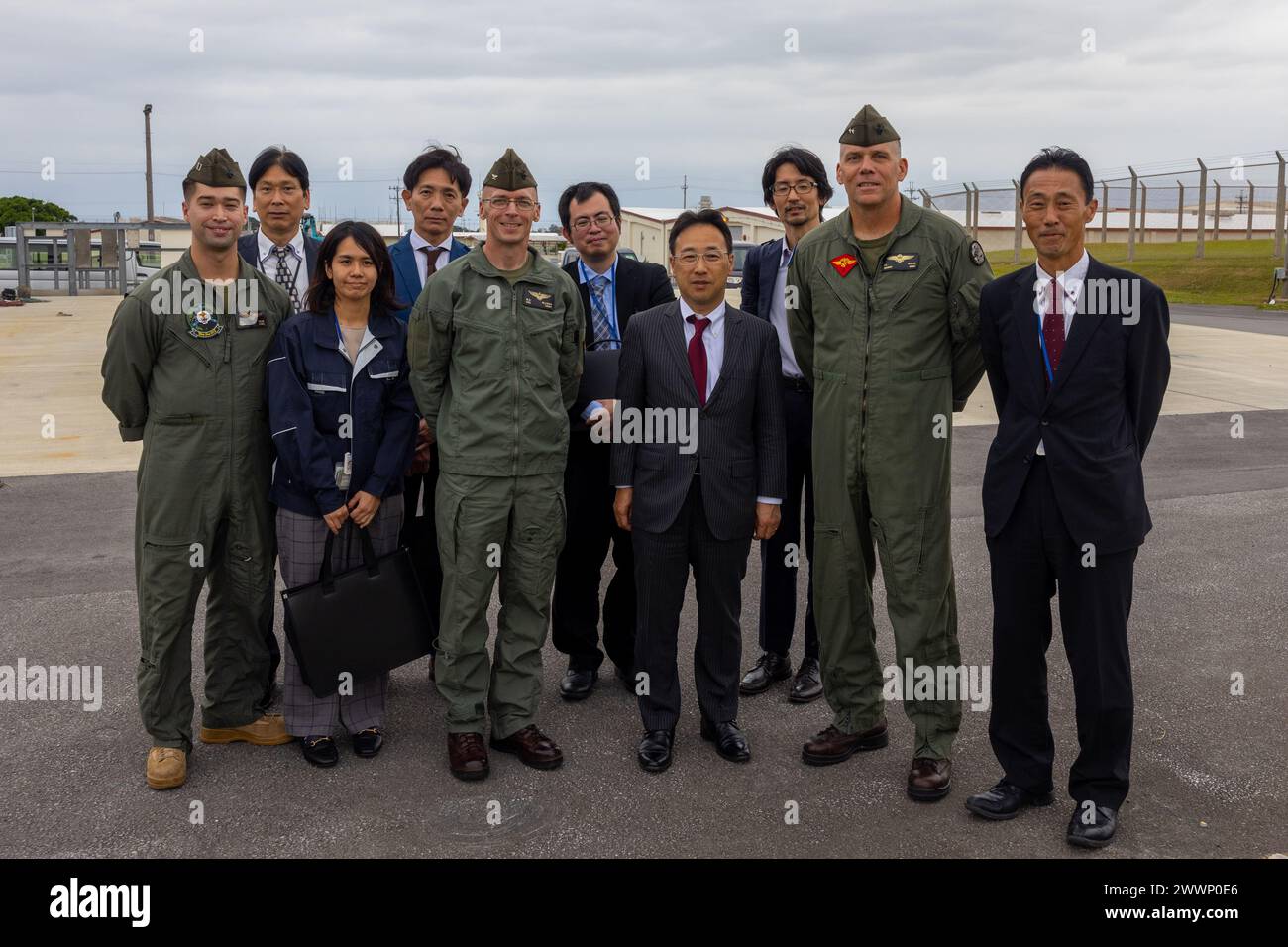 Mr. Shinya Ito, center, director general of the Okinawa Defense Bureau, poses for a photo with ...