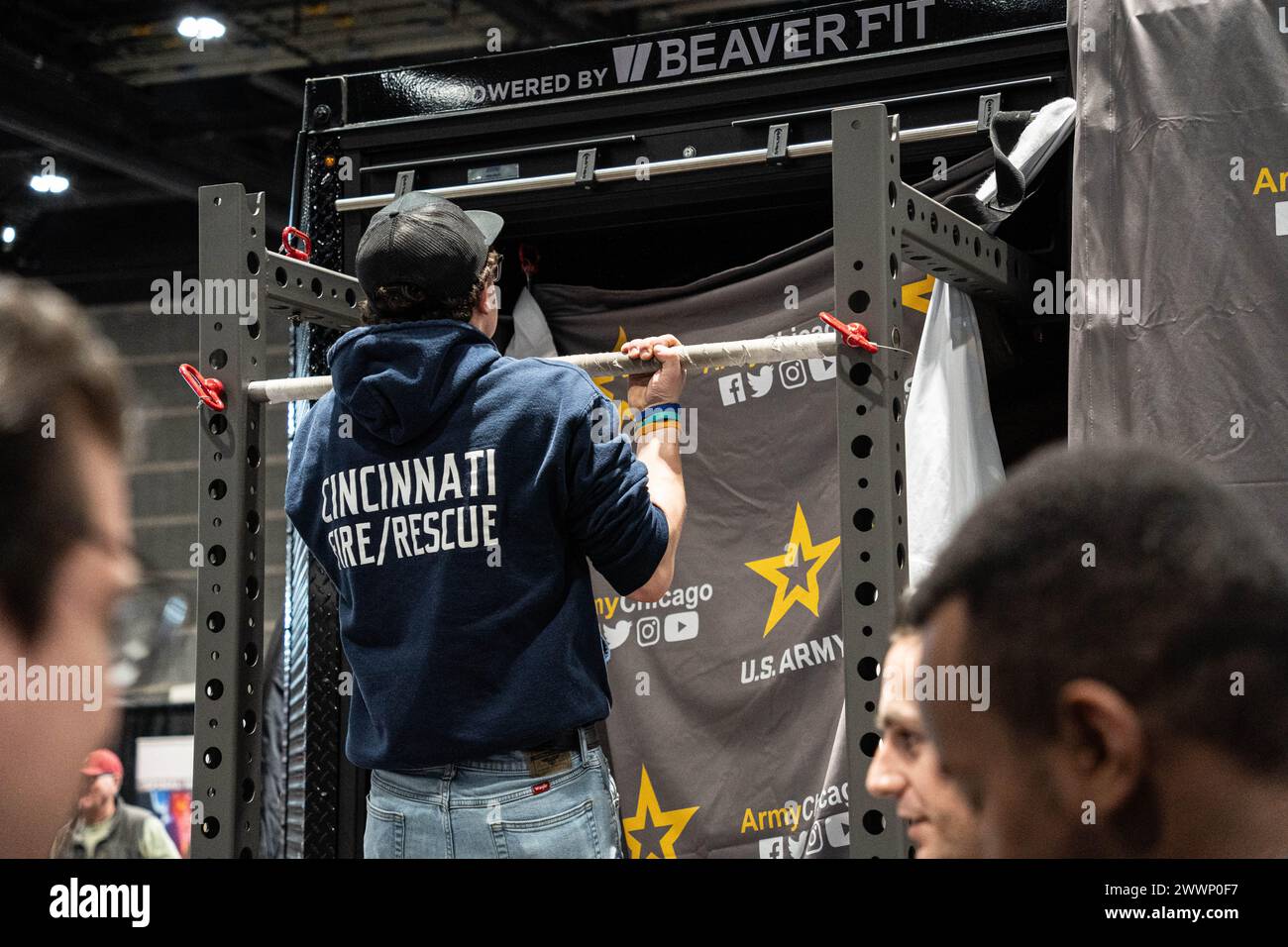 A spectator conducts pull-ups to win an Army T-shirt during the Chicago ...
