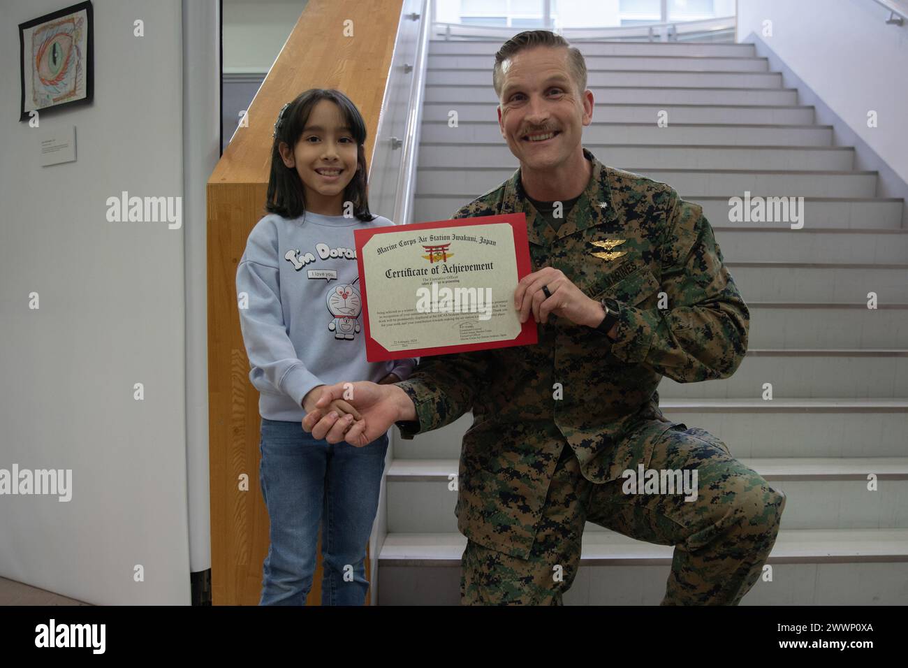 A student from Matthew C. Perry Primary School, left, poses for a ...