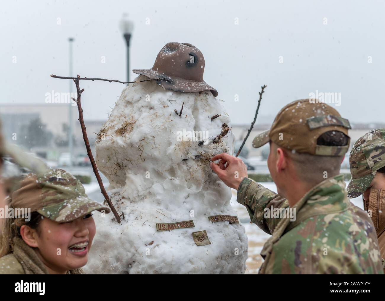 Students of Airman Leadership School Class 24-B build a snowman during ...