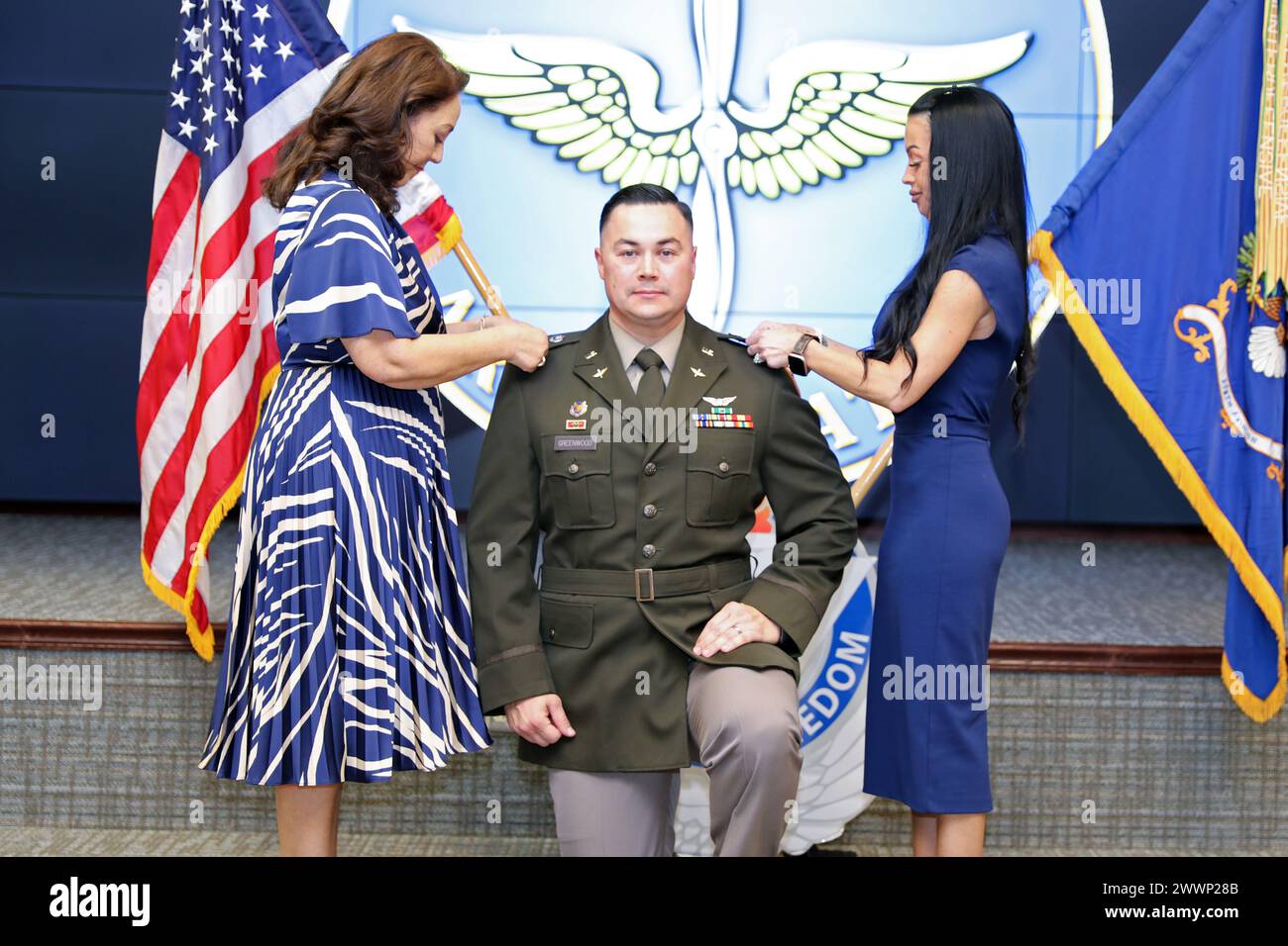 Maj. Bryce R. Greenwood's gold oak leaf clusters are pinned onto his ...