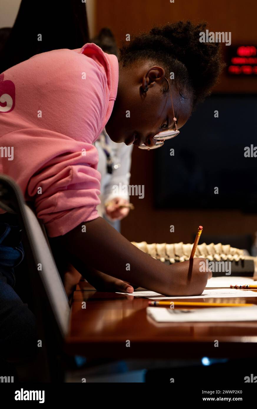 A student from the Aliamanu Middle School records data as part of a ...