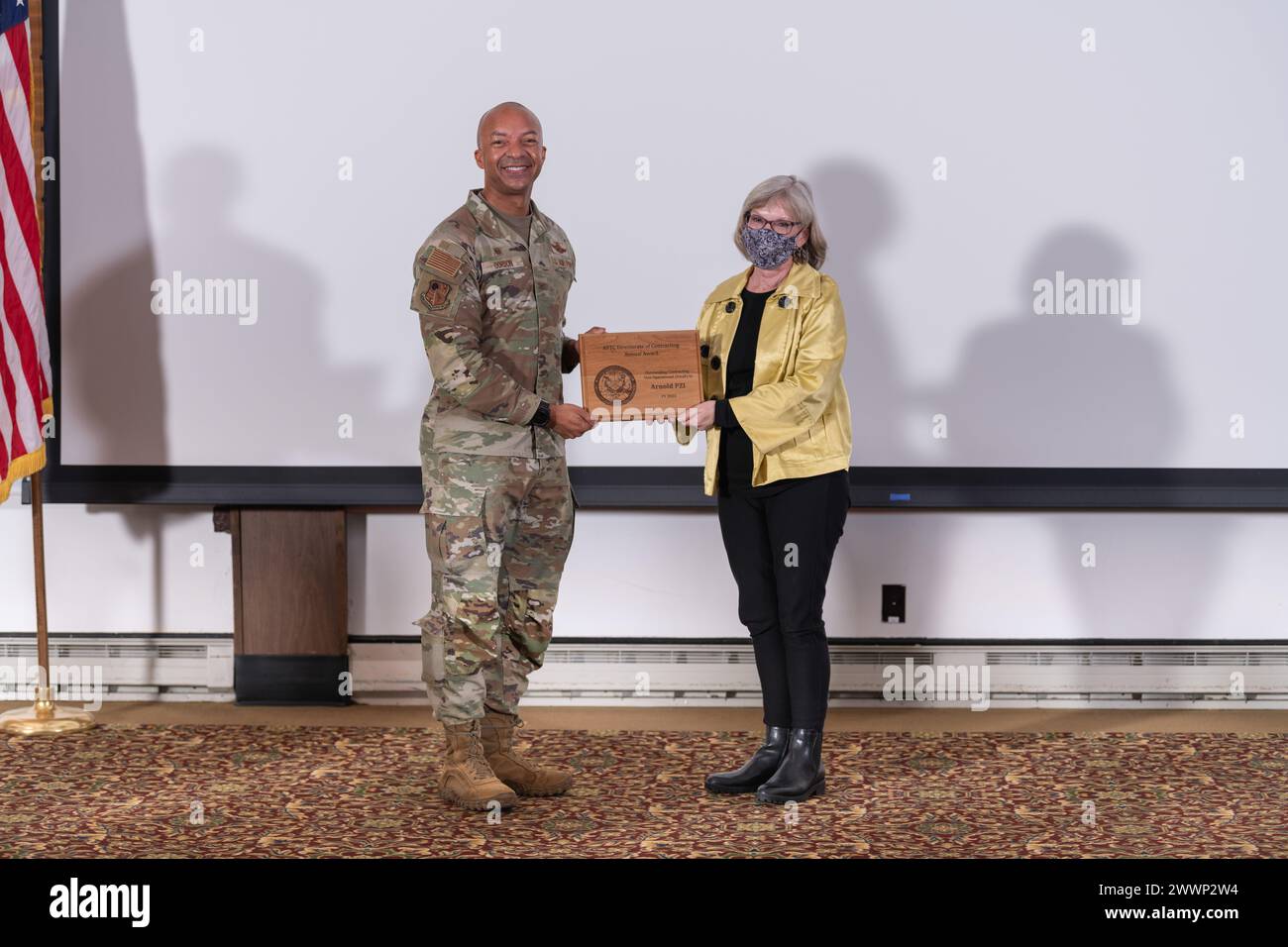 Director of Contracting Amy Foster accepts the award for Outstanding ...