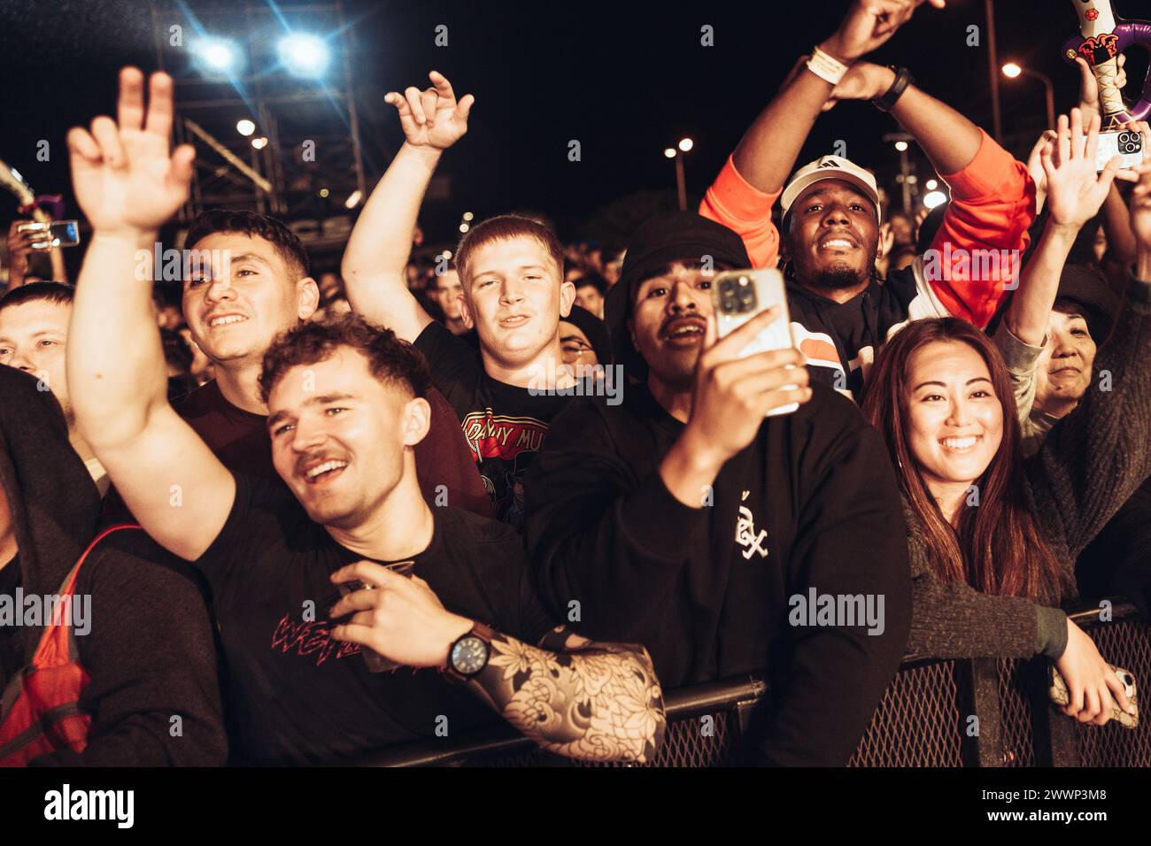 Attendees cheer during a performance by Kyle Harvey, a musical artist ...