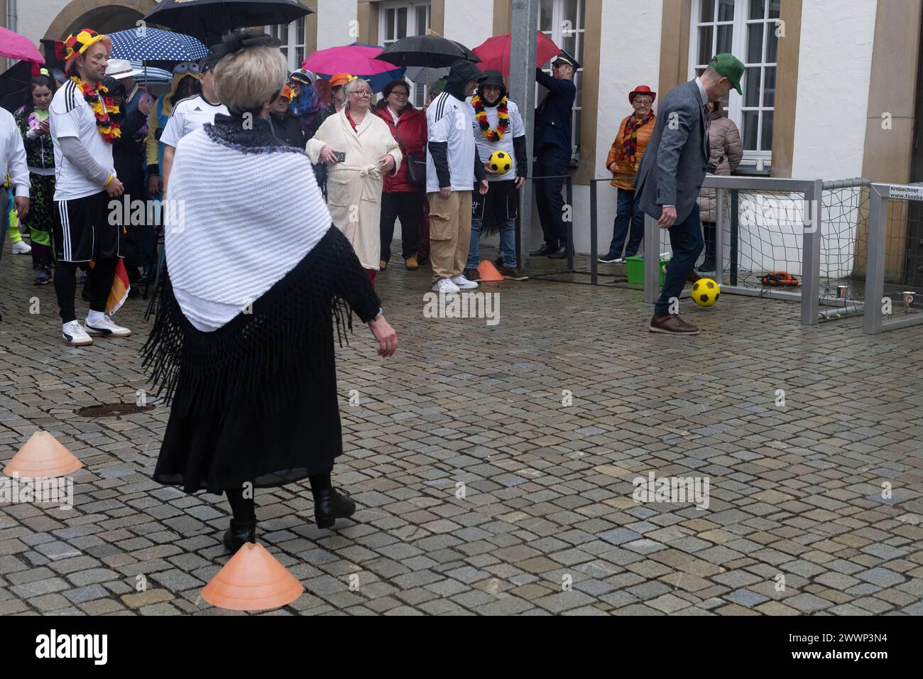 A Ladies Fasching participant kicks a soccer ball in Bitburg, Germany ...
