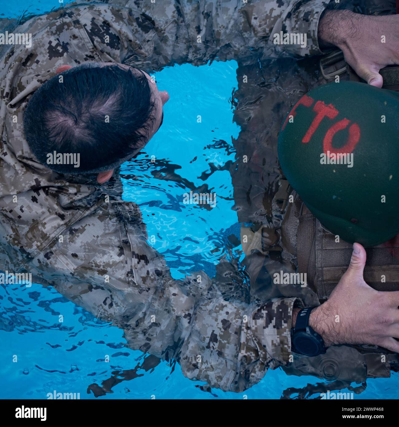 A U.S. Marine swims with his pack during swim qualification on Camp H.M ...