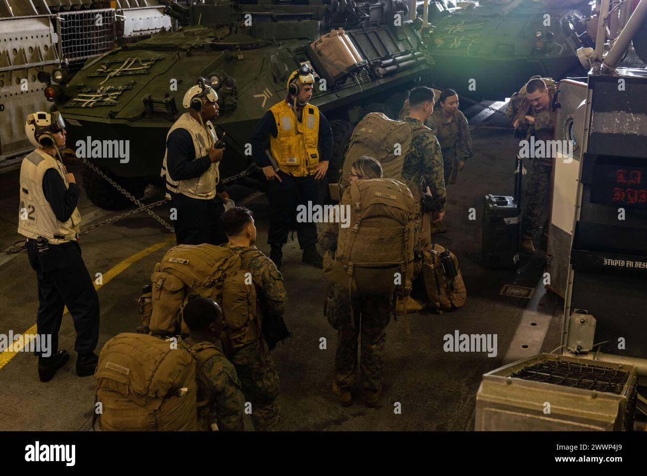 U.S. Marines assigned to the 15th Marine Expeditionary Unit load onto ...