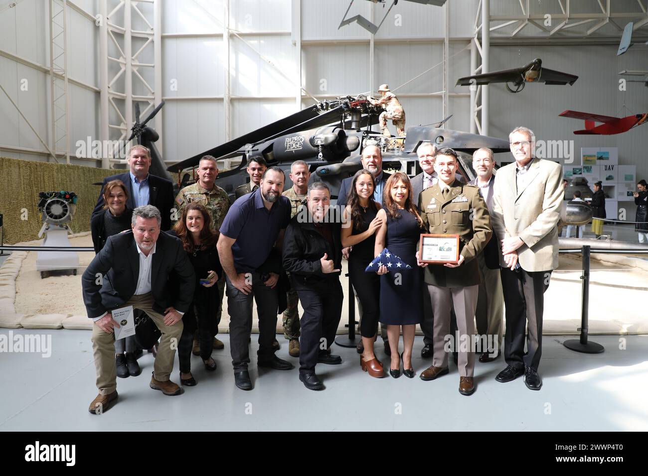 Family and friends gather around Warrant Officer Paul D. Kelly after ...