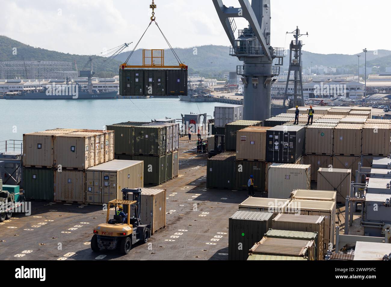 A shipping container is lifted out of Military Sealift Command (MSC ...