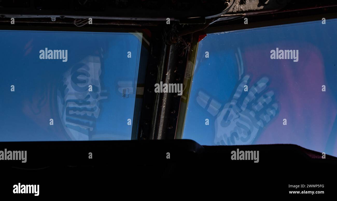 The 23rd Bomb Squadron flag reflects off of the windshield of a B-52H ...