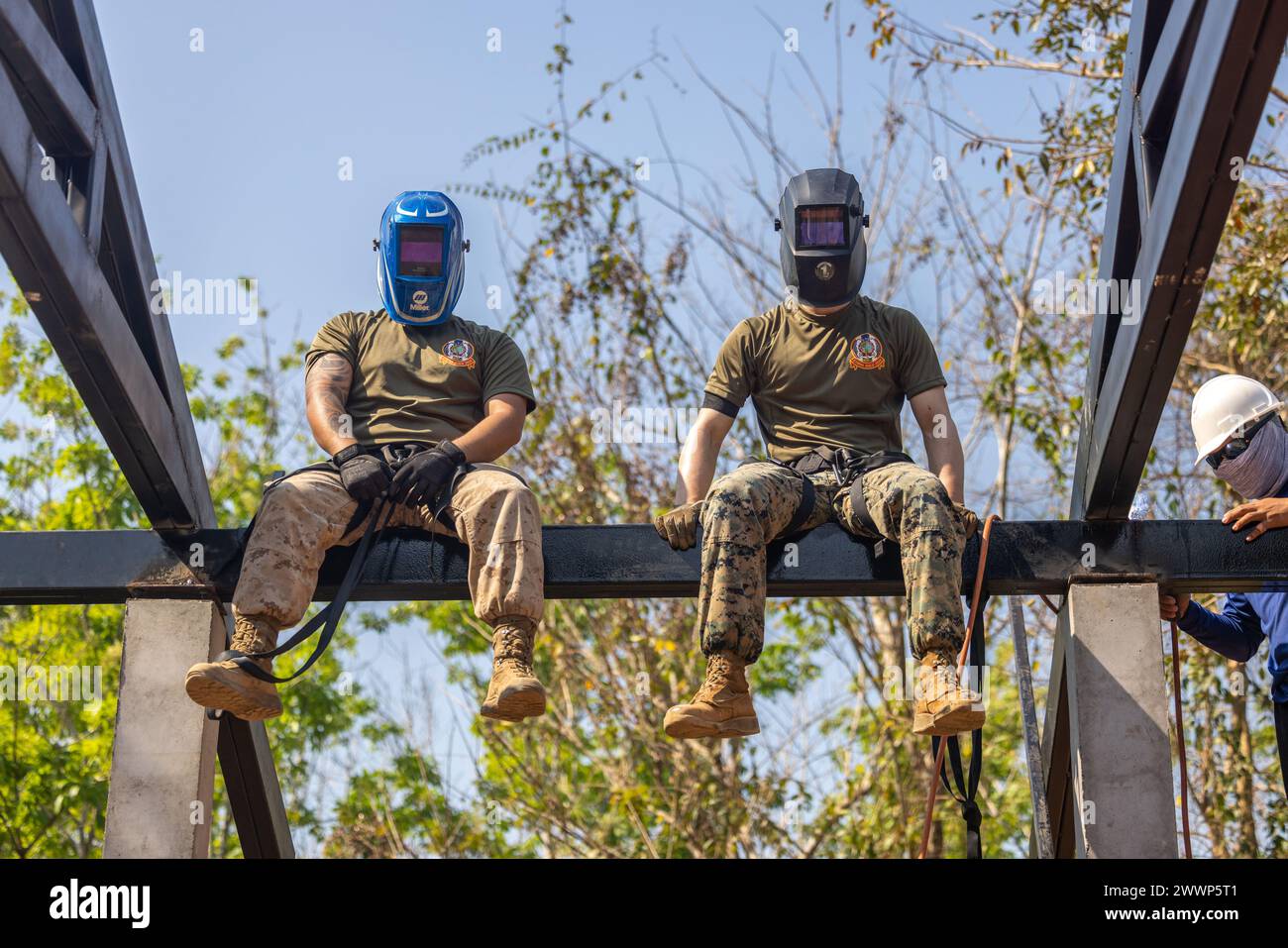 U.S. Marine Corps Sgt. Damion Lopez, left, a metal worker and resident ...