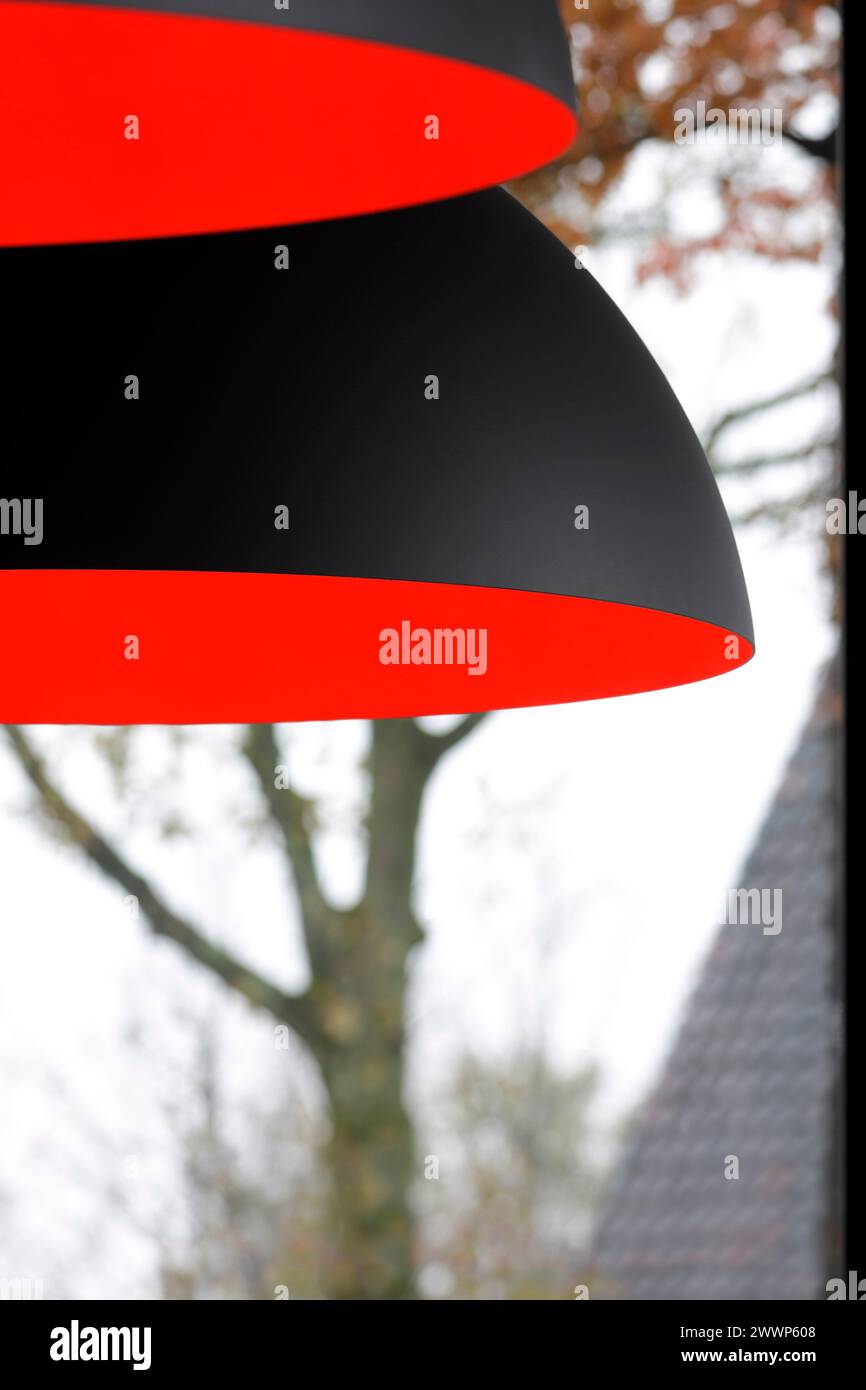 Half-globe ceiling lamps with orange interior in restaurant. Dutch ...